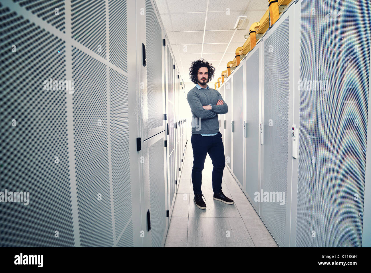 Young technician working in white server room Stock Photo - Alamy