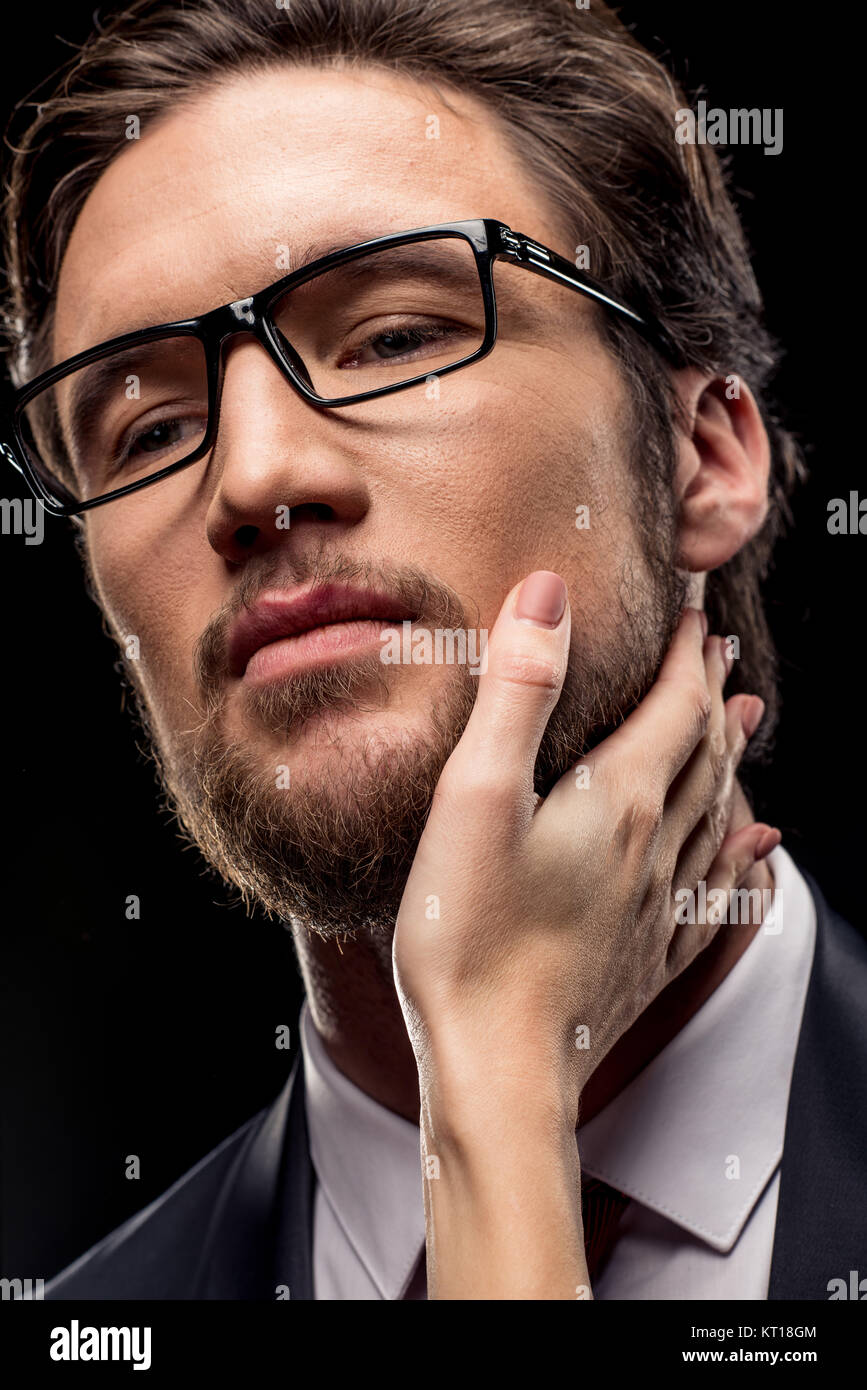 Businessman with female hand on face Stock Photo - Alamy