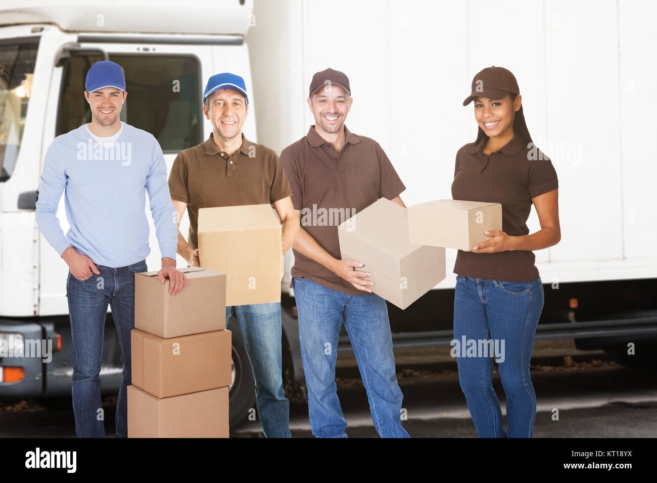 Group of delivery people with boxes Stock Photo - Alamy