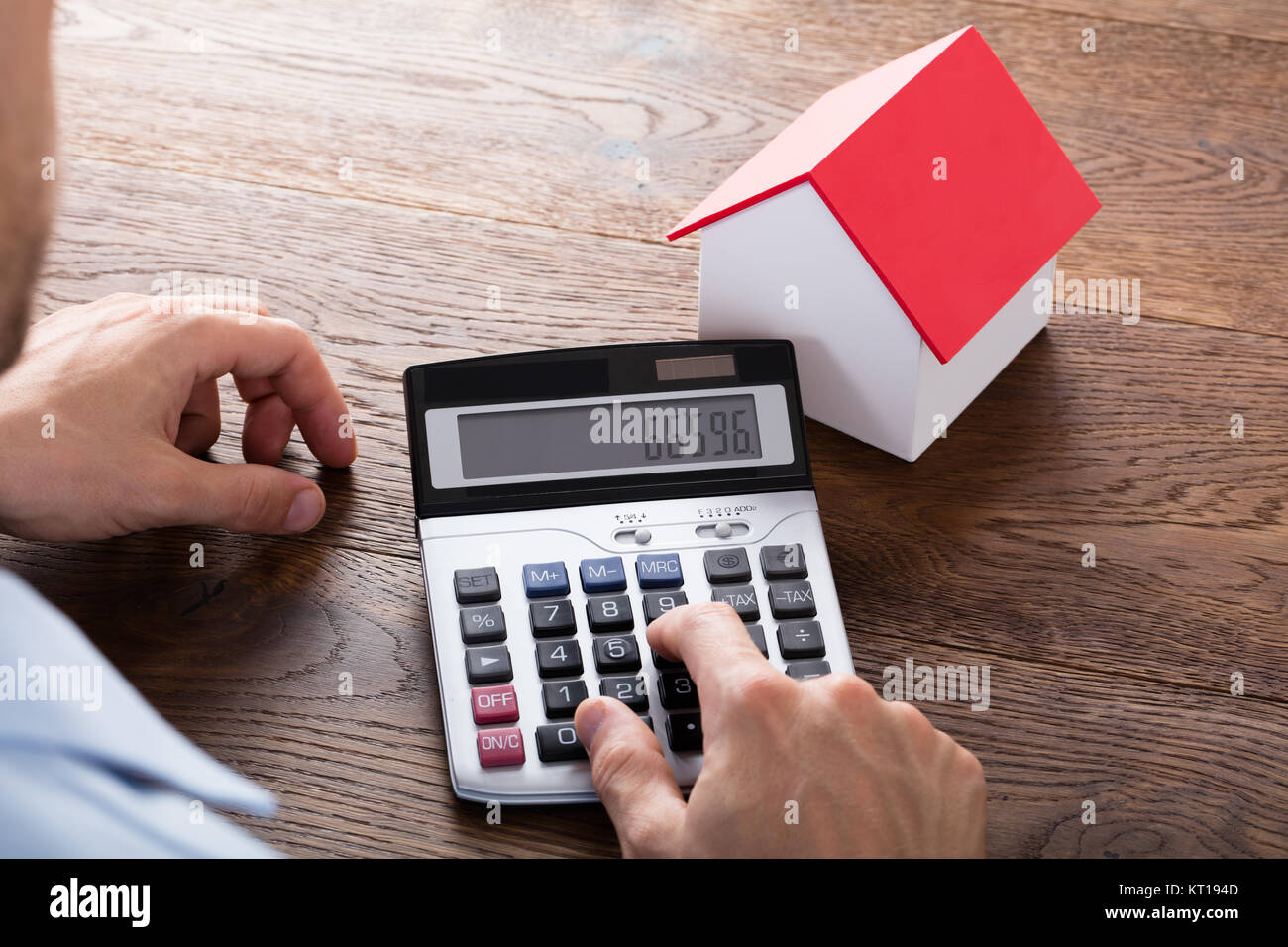 Person Doing Calculation Of House Model Stock Photo - Alamy