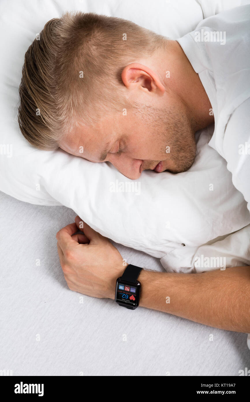 Man Sleeping With Smart Watch In His Hand Stock Photo - Alamy