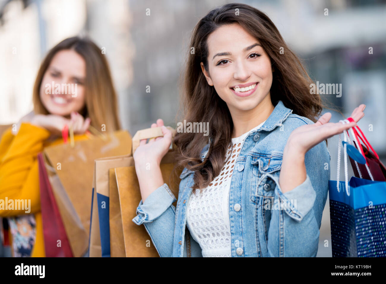 Happy girls shopping in late autumn. bags, walking, holidays Stock ...