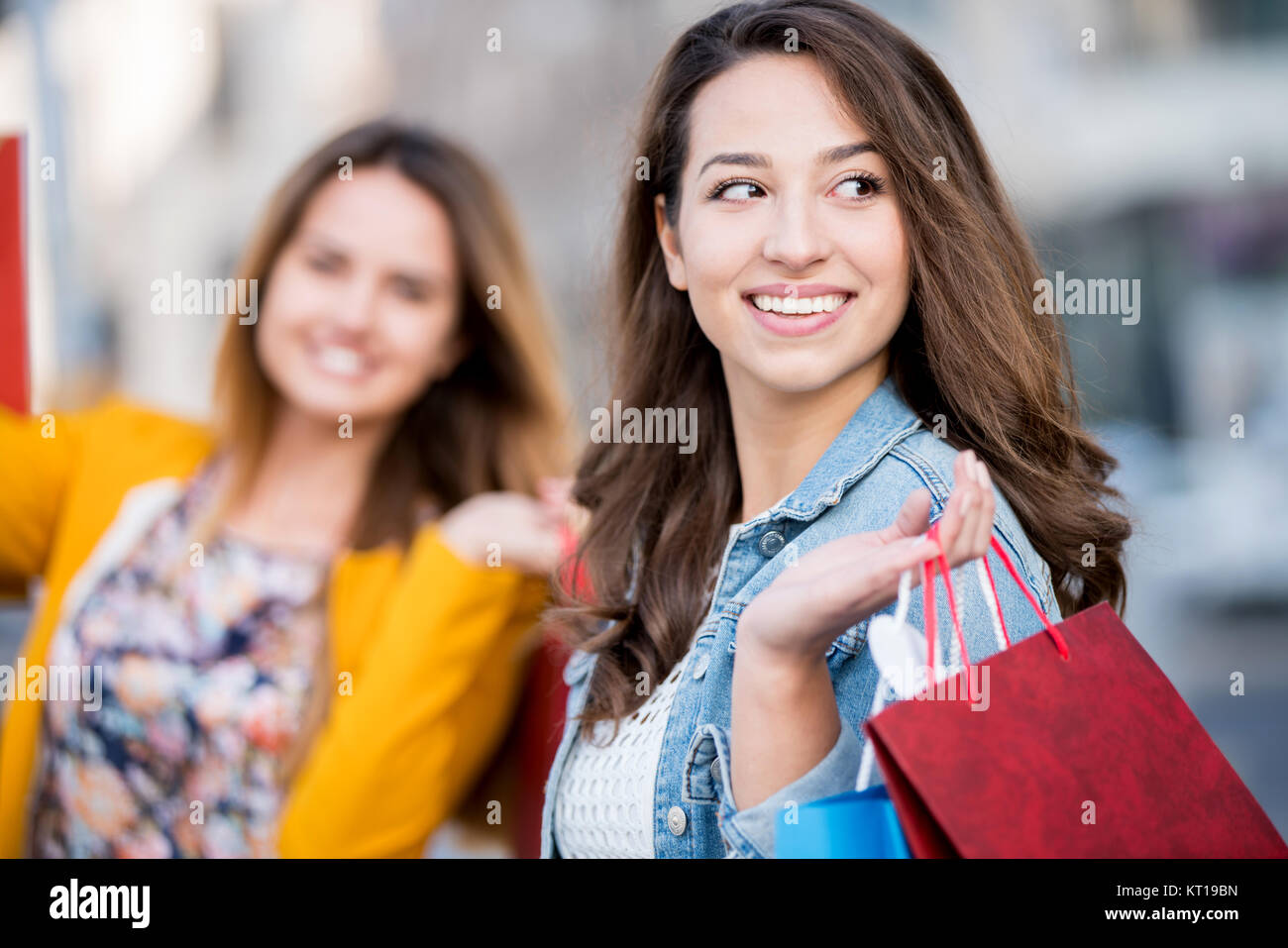 Happy girls shopping in late autumn. bags, walking, holidays Stock ...