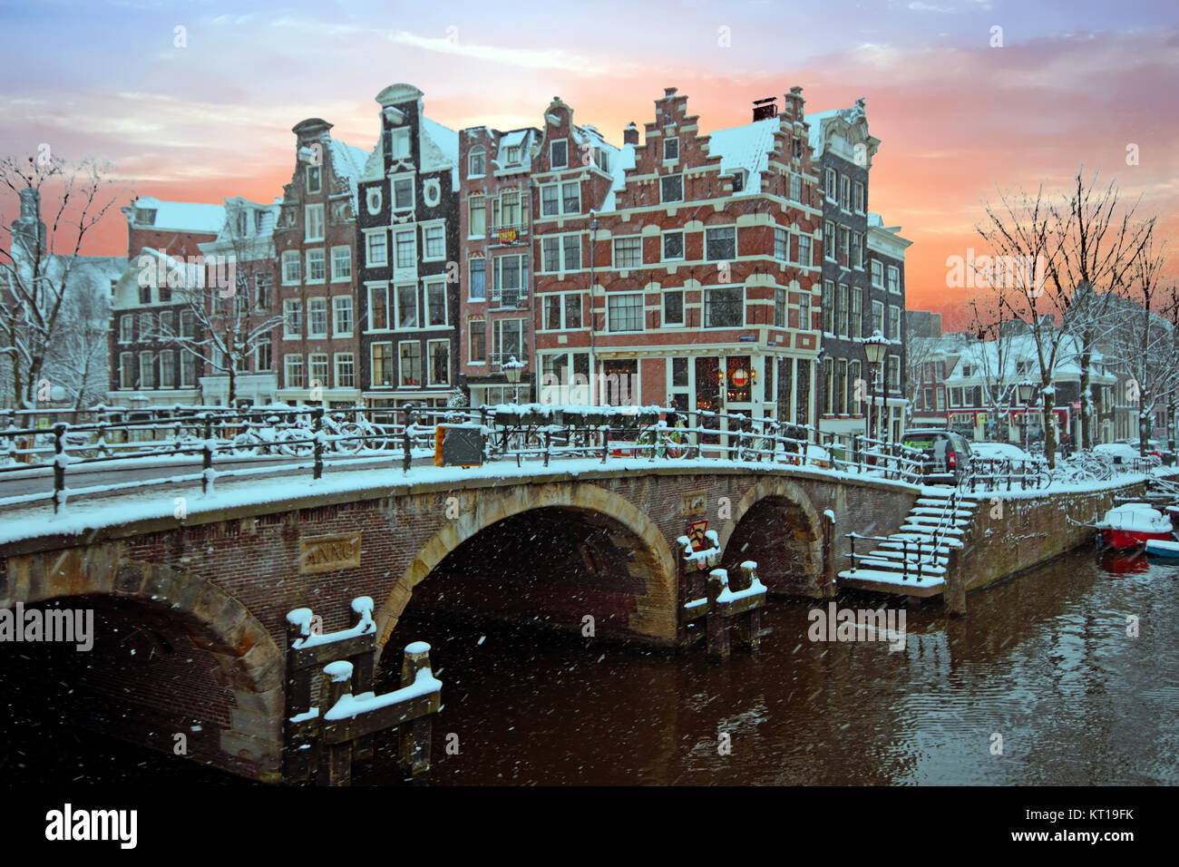 Snowy Amsterdam in the Netherlands in winter at sunset Stock Photo - Alamy