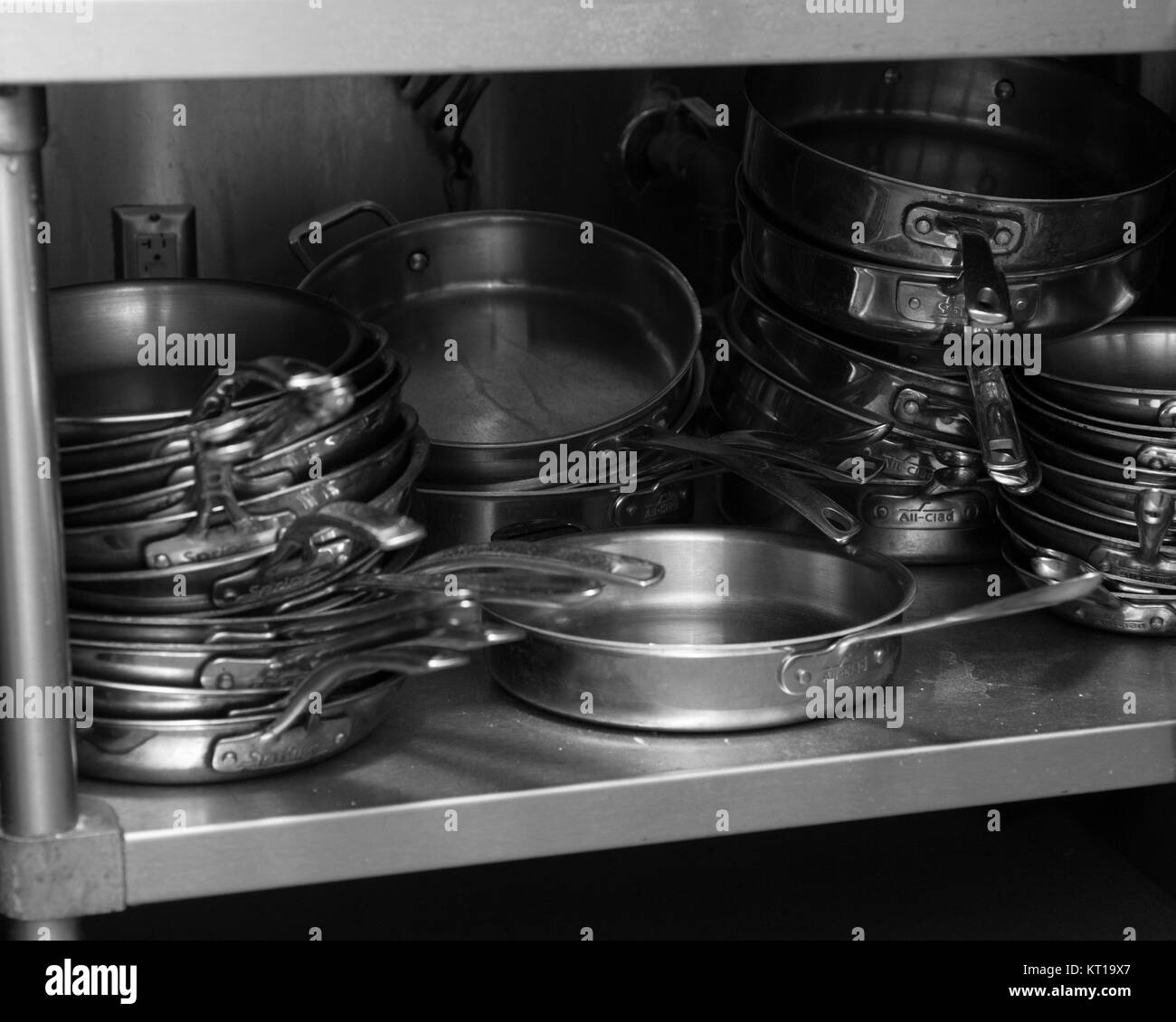 Stack of stainless steel pans Stock Photo - Alamy