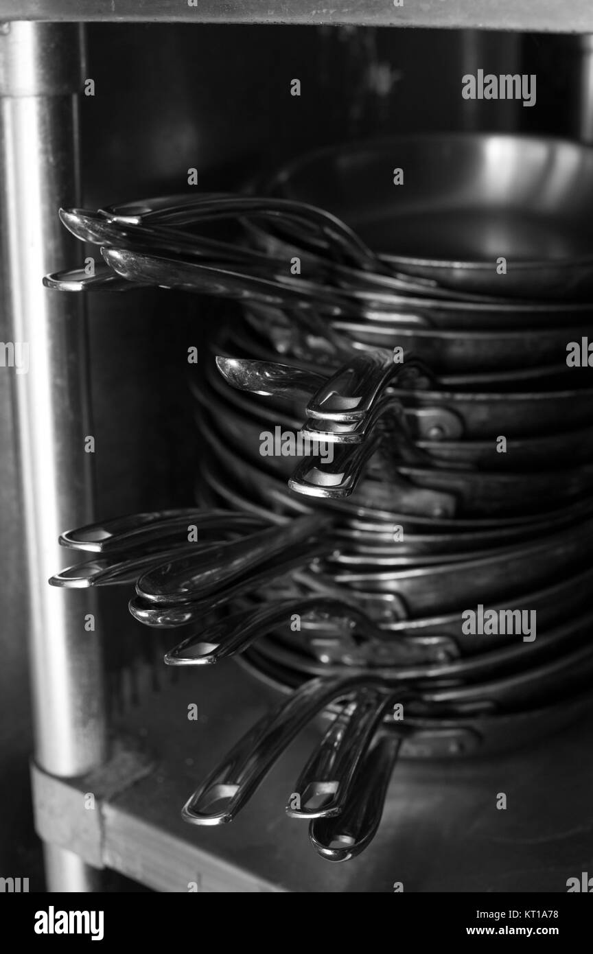 Stack of stainless steel saute pans Stock Photo - Alamy