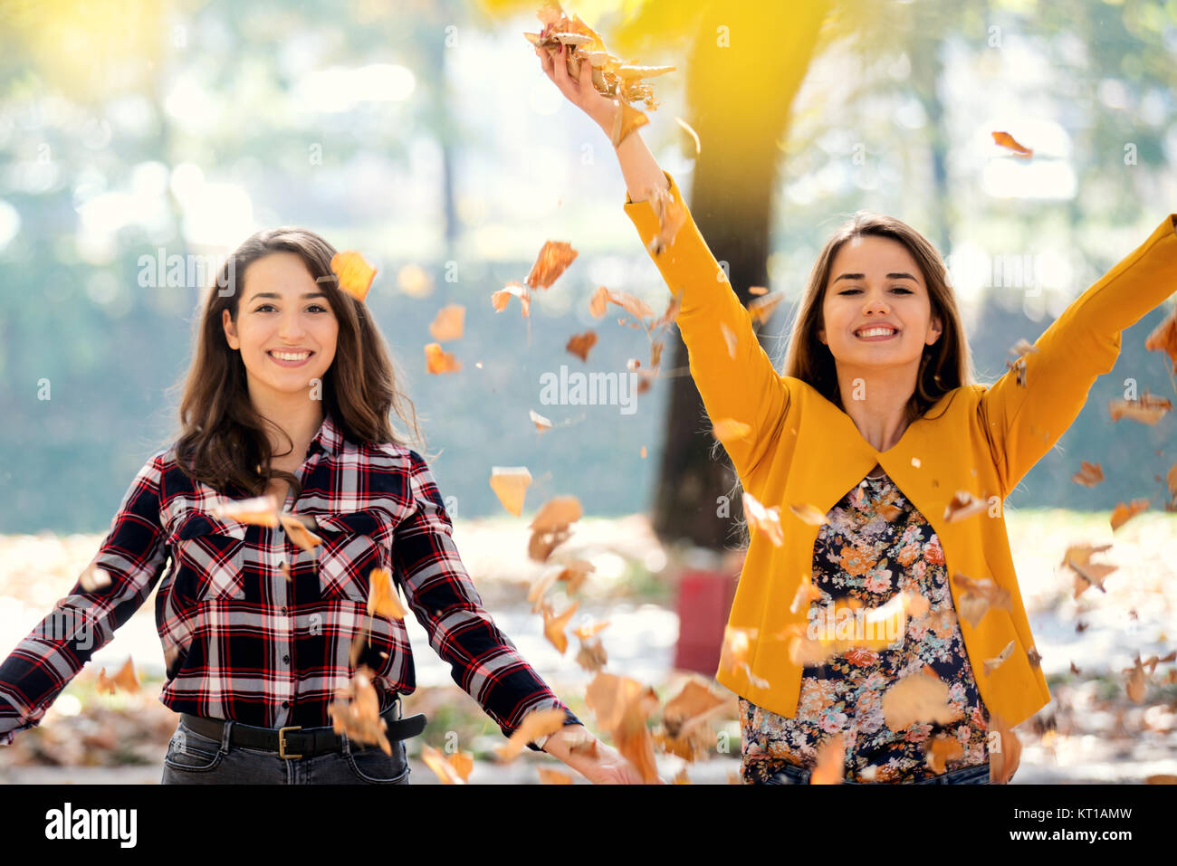 Having fun outside in the late autumn. playing with yellow leaves, fun ...