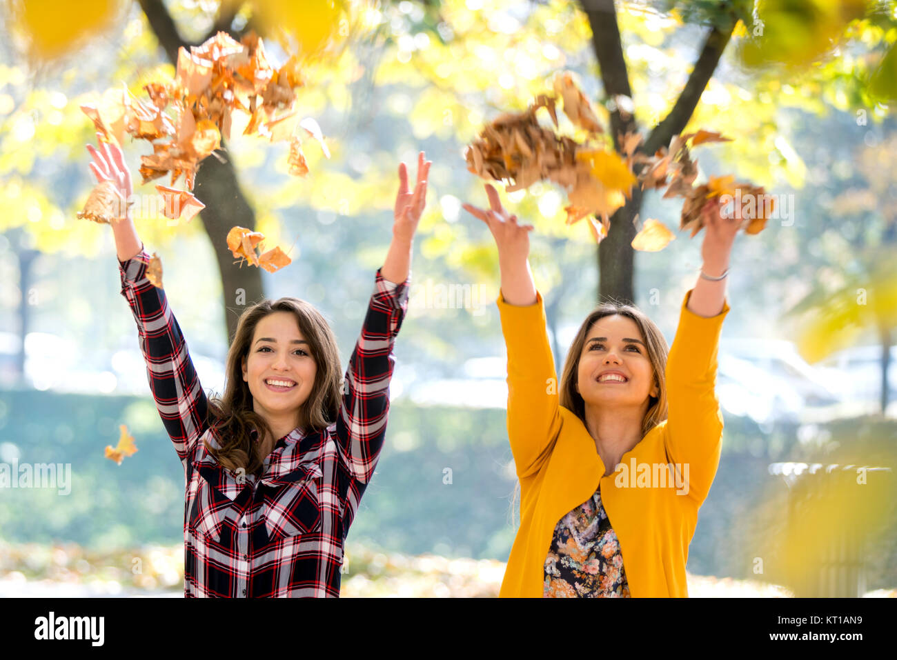 Having fun outside in the late autumn. playing with yellow leaves, fun ...
