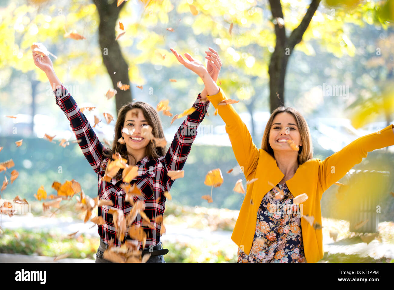 Having fun outside in the late autumn. playing with yellow leaves, fun ...