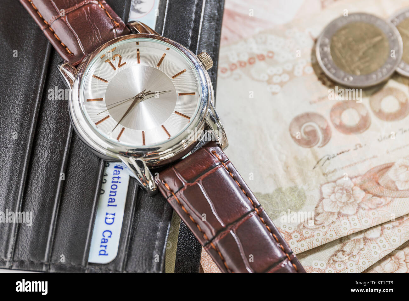 Watch and wallet on banknote Stock Photo - Alamy