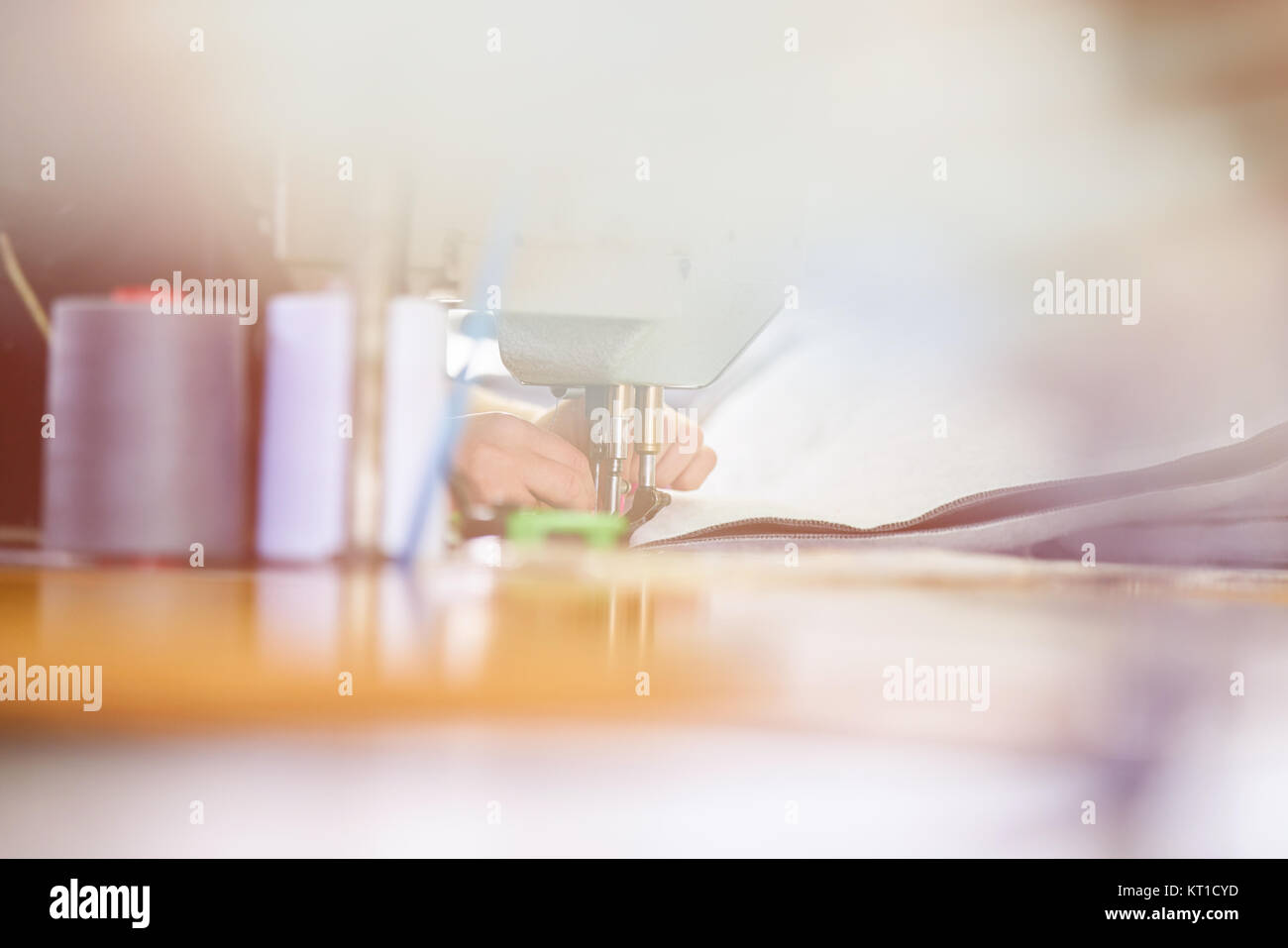 Seamstress or worker in a factory sewing with a industrial sewing ...