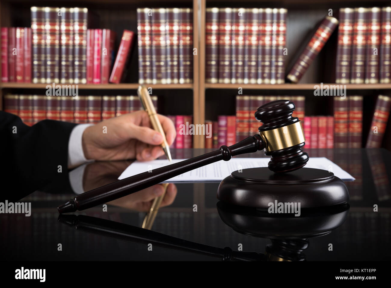 Close-up Of Judge Writing On Paper And Gavel At Desk Stock Photo - Alamy