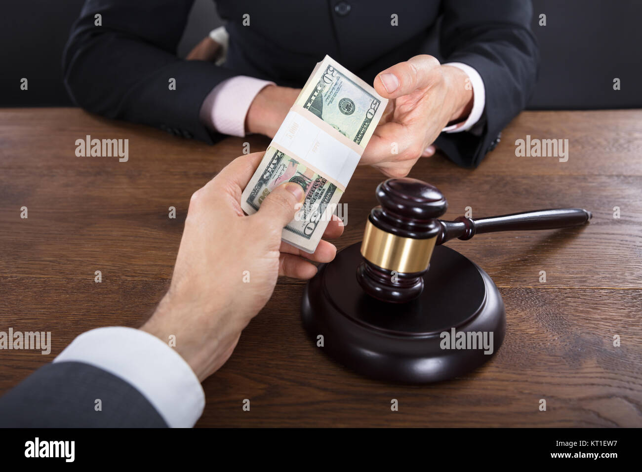 Businessman Giving A Bribe To A Judge Stock Photo - Alamy