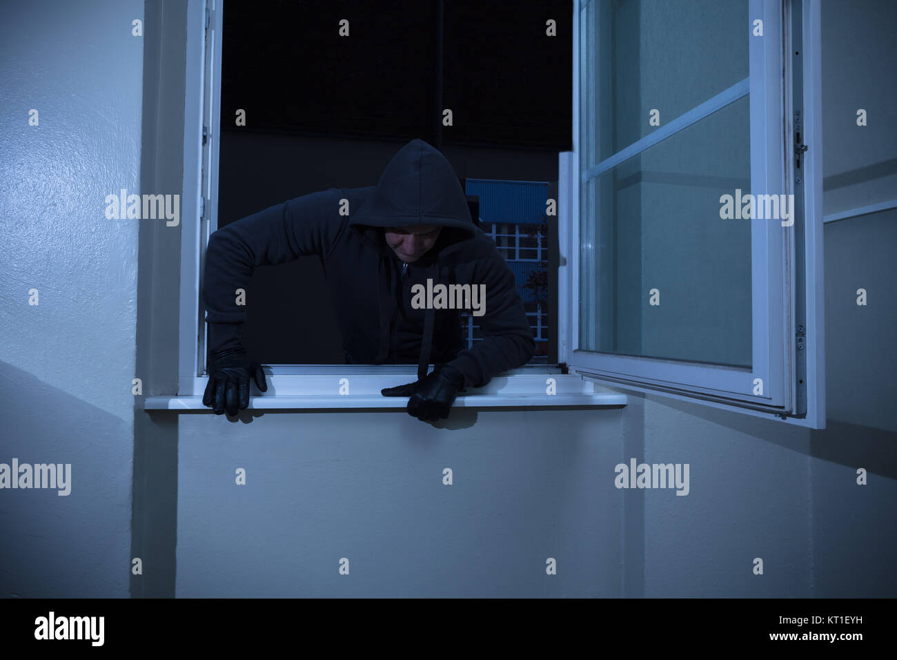 Burglar Entering Through The Window Stock Photo - Alamy