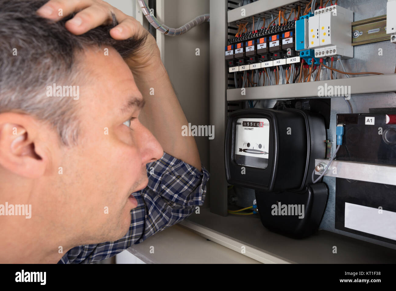 Shocked Man Looking At Meter Stock Photo - Alamy