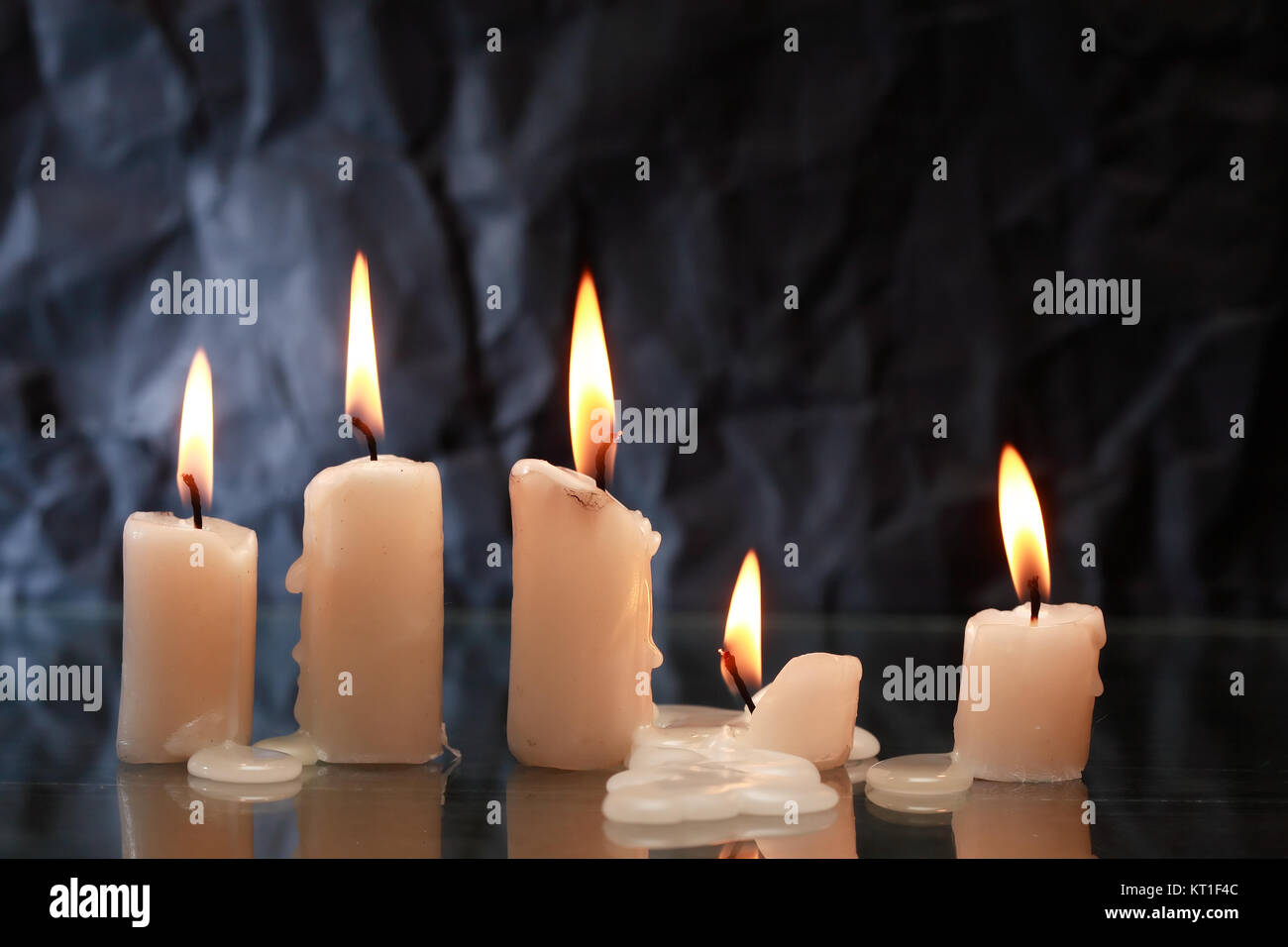 Set of lighting candles with fire and smoke on nice dark background ...