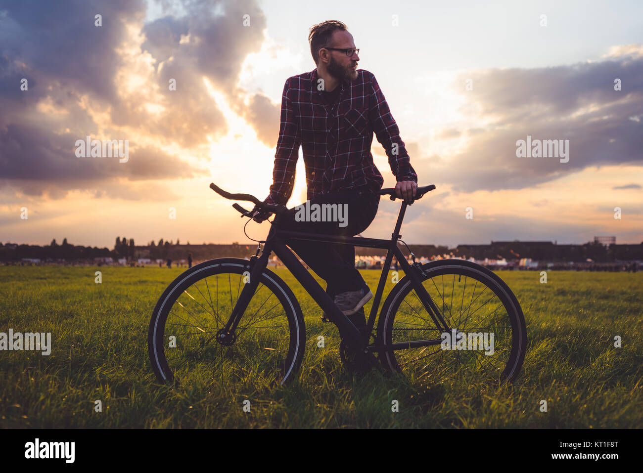 35 year old hipster male with his bike at Templehof Field in Berlin ...