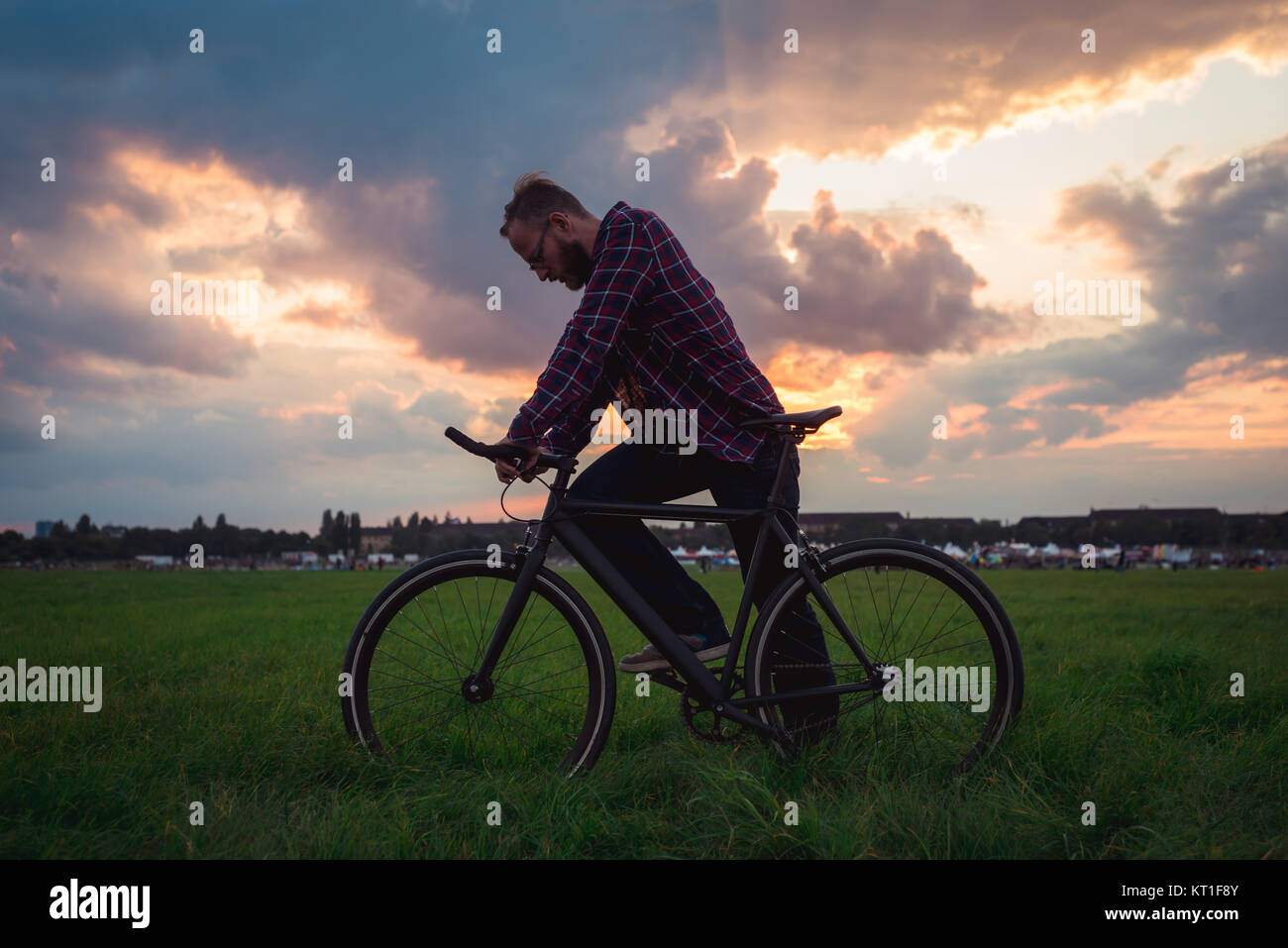 35 year old hipster male with his bike at Templehof Field in Berlin ...