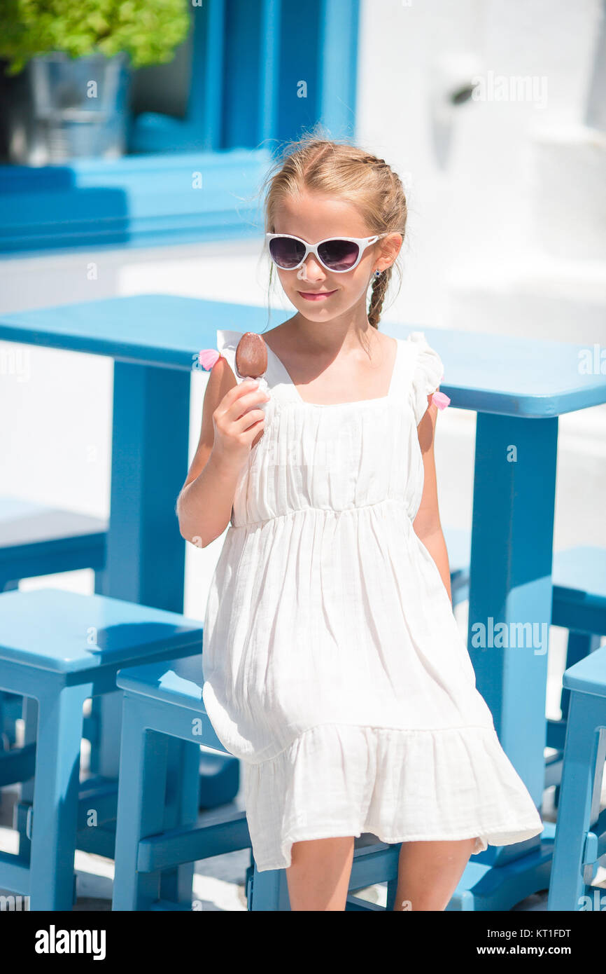 Adorable little girl at street of typical greek traditional village on ...