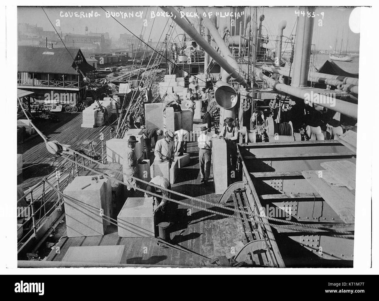 A photograph of buoyancy boxes being covered on the deck of the vessel ...