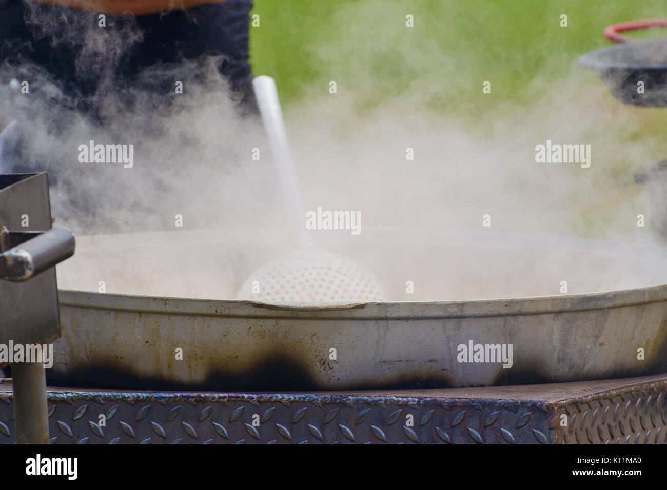 In a wide pot is preparing a large portion of barley porridge Stock ...