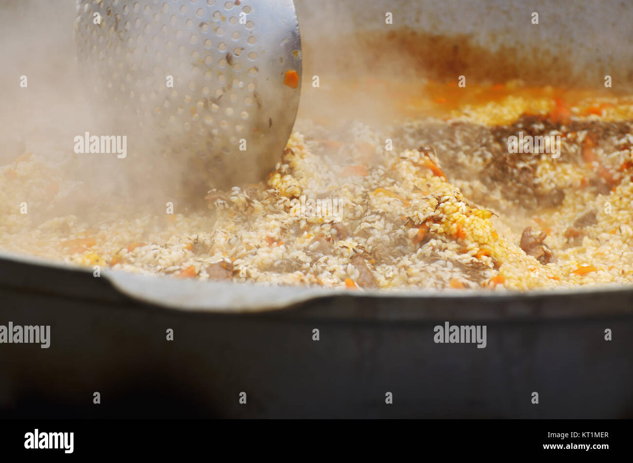 In a wide pot is preparing a large portion of barley porridge Stock ...