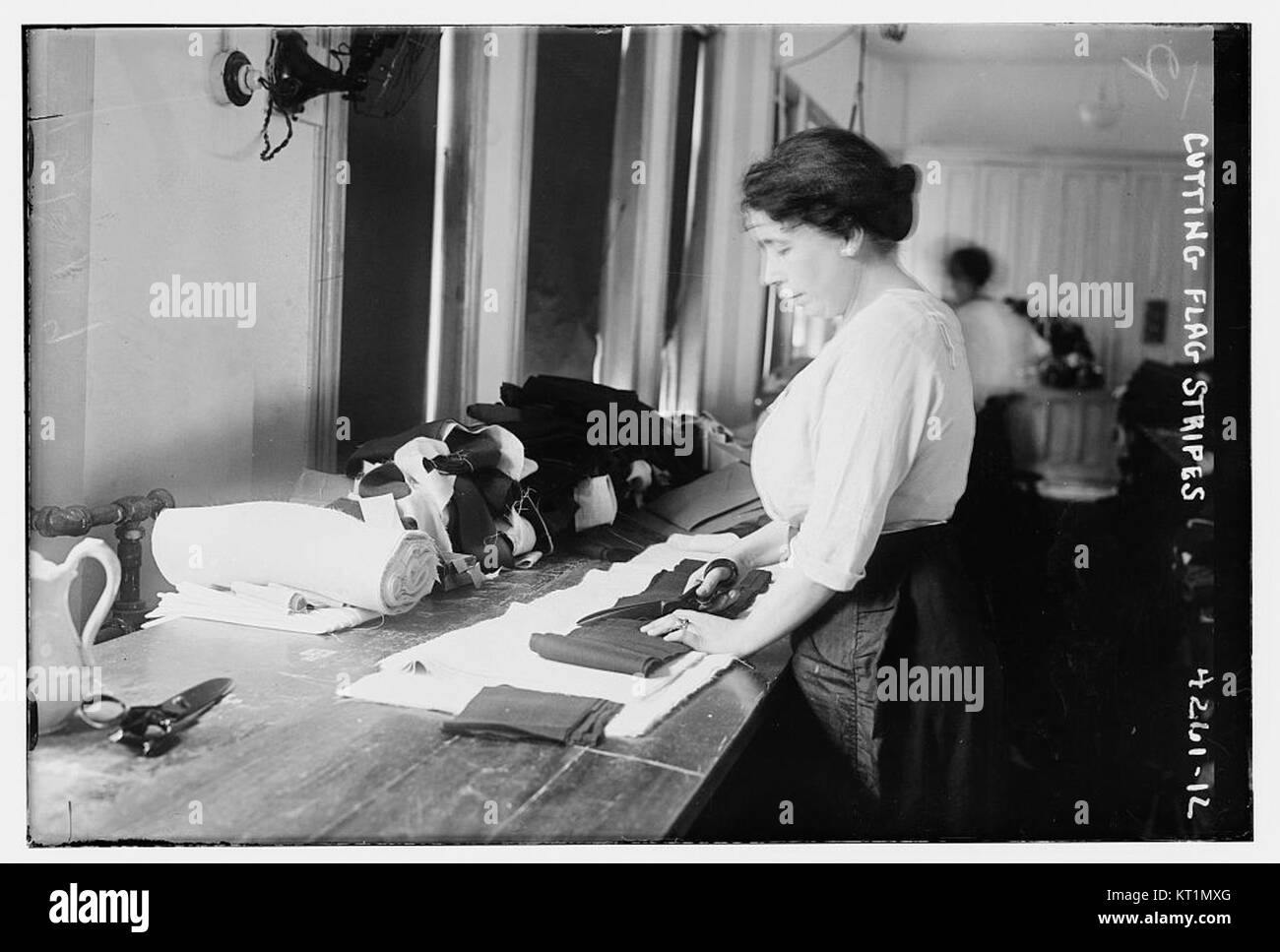 This image shows the process of cutting flag stripes, a detail of flag ...