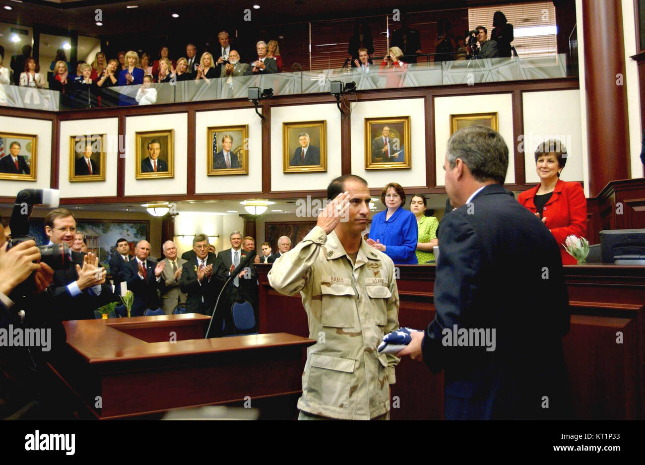 1st Sergeant Baker presents a U.S. flag from Alpha Company of the ...