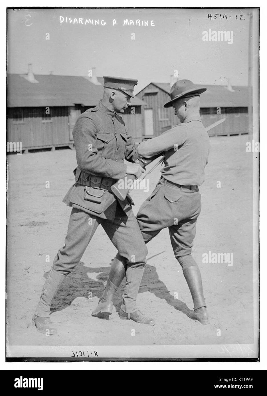 This photograph depicts the process of disarming a Marine, likely ...