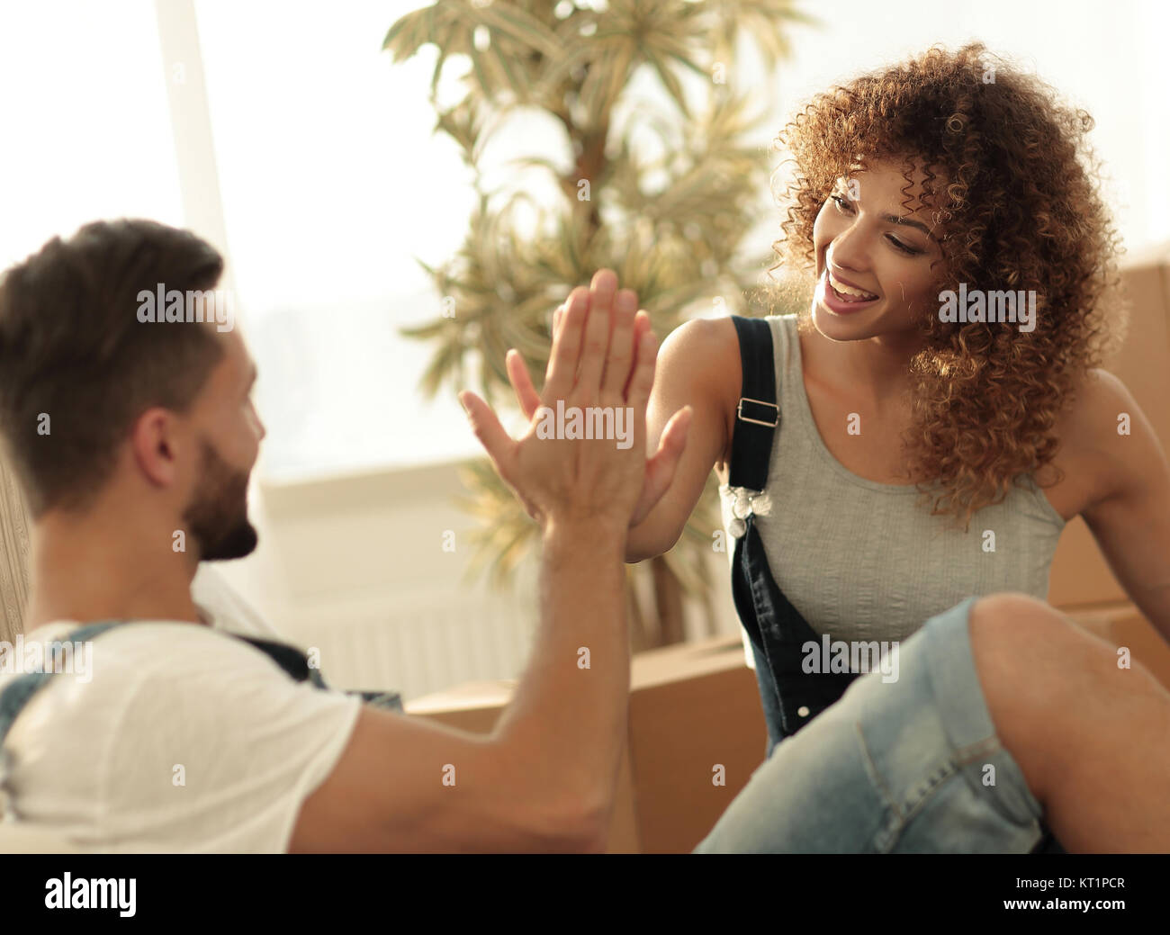 young couple giving each other five with a new home Stock Photo - Alamy