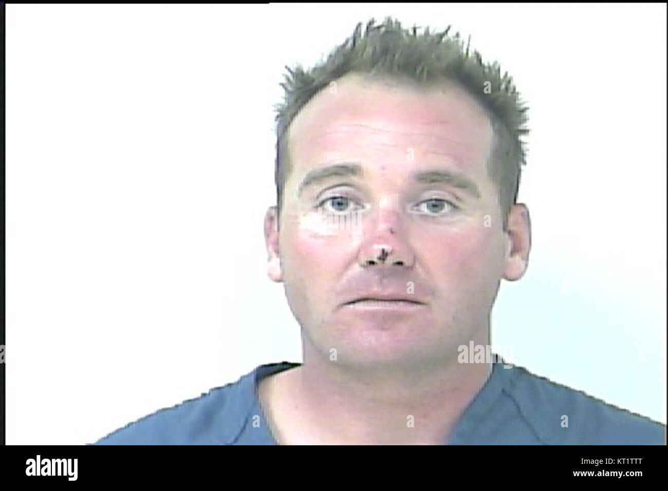 The image captures an arrest photo of Eric Langill, a figure involved ...