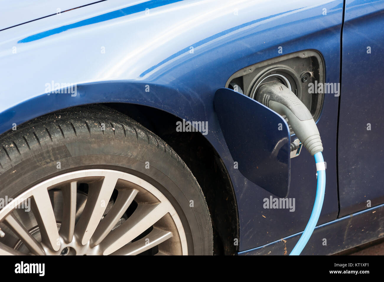 charging blue electrical car close-up Stock Photo - Alamy