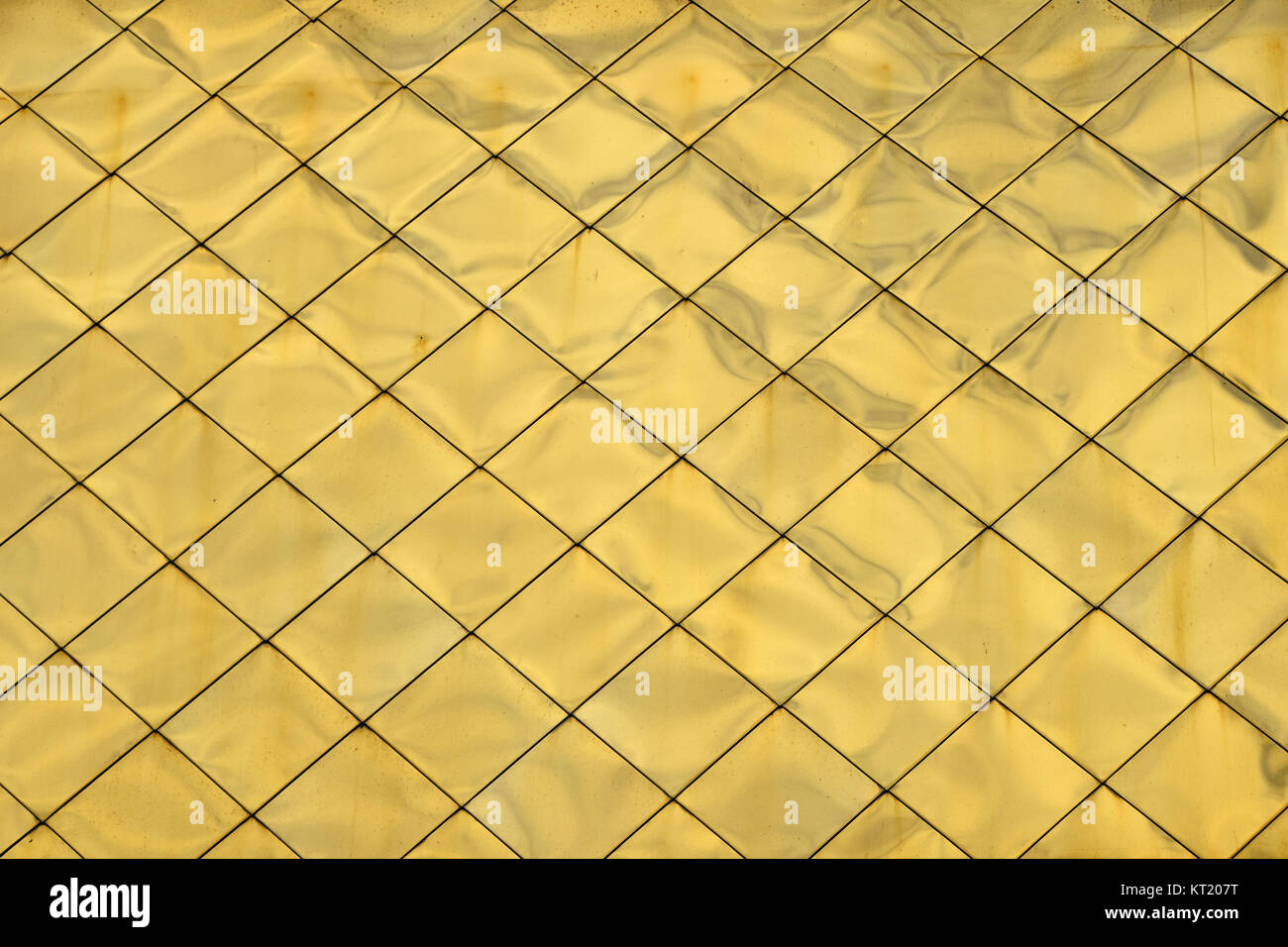 Golden metal roof tile panels texture background Stock Photo - Alamy