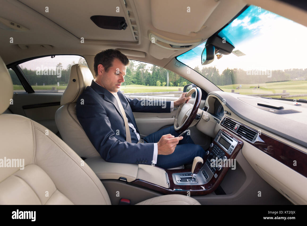Man using cell phone while driving Stock Photo - Alamy