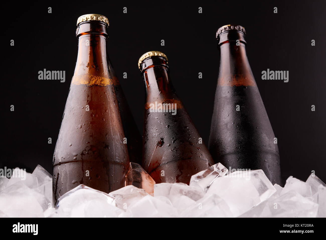 Bottles of beer in ice cubes Stock Photo - Alamy
