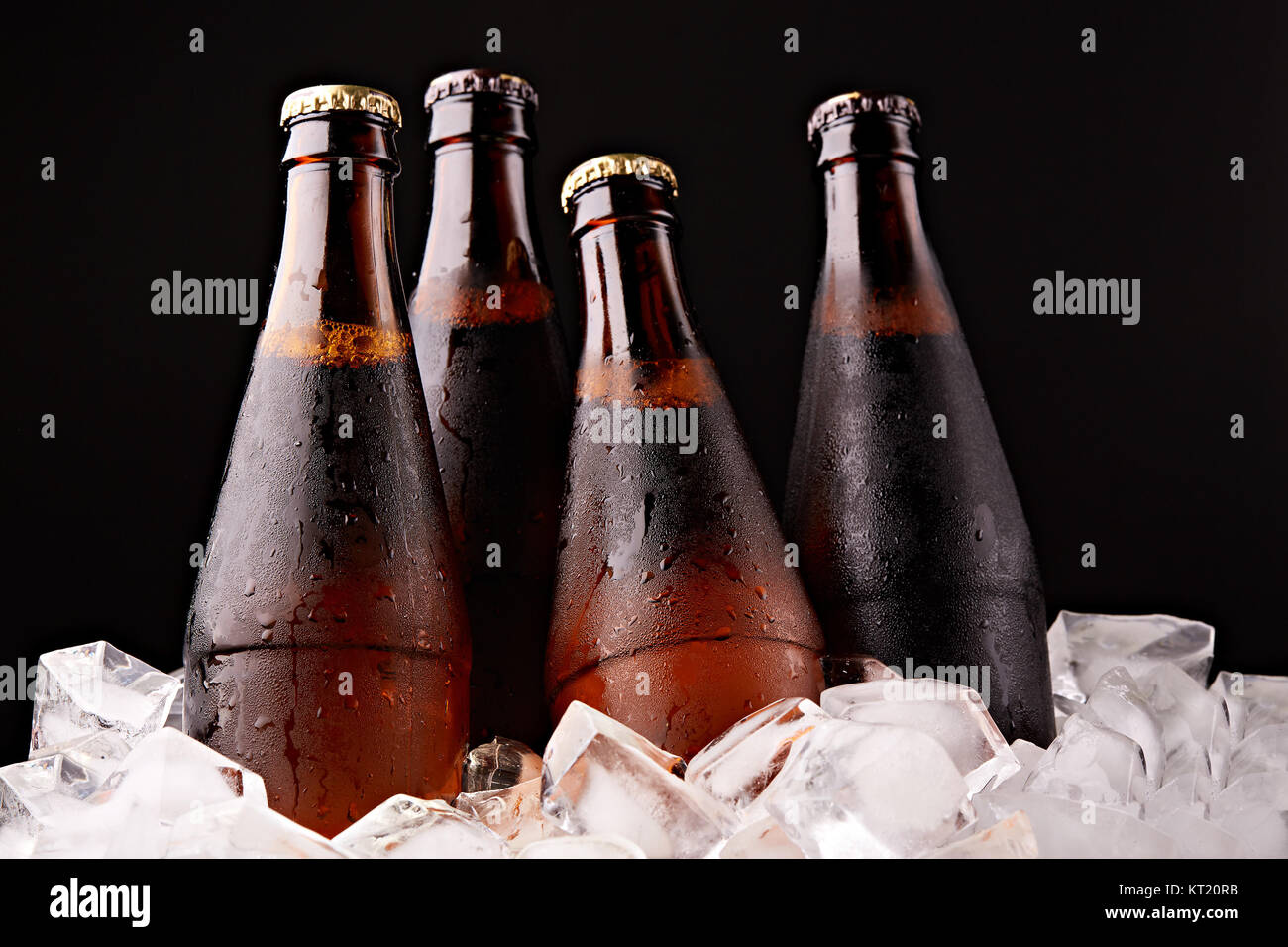 Bottles of beer in ice cubes Stock Photo - Alamy