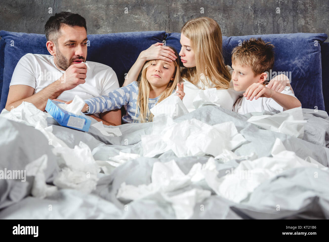 Sick family on bed Stock Photo - Alamy