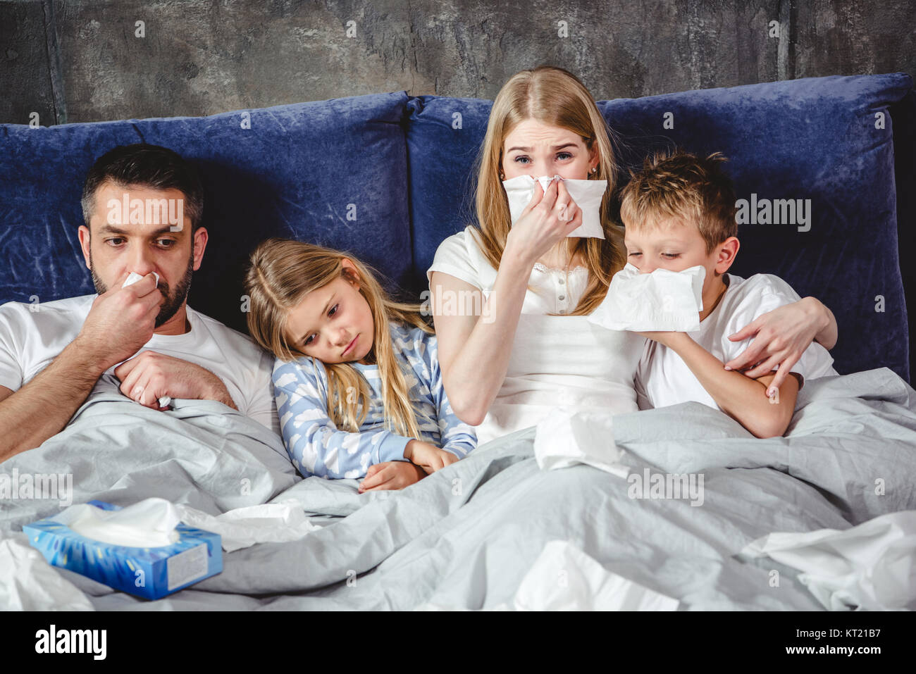 Sick family on bed Stock Photo - Alamy