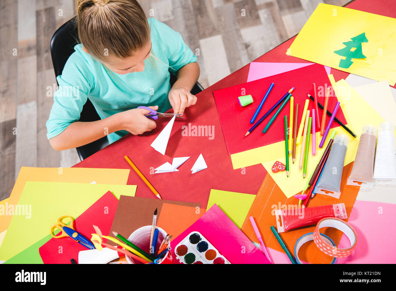 Schoolchild cutting paper Stock Photo - Alamy