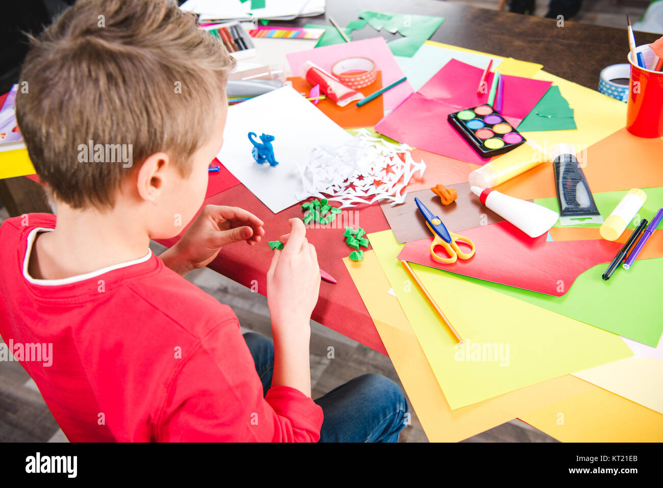 Schoolchild making toy from plasticine Stock Photo - Alamy