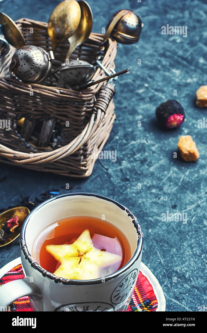 Cup of herbal tea decorated with star with apple Stock Photo - Alamy