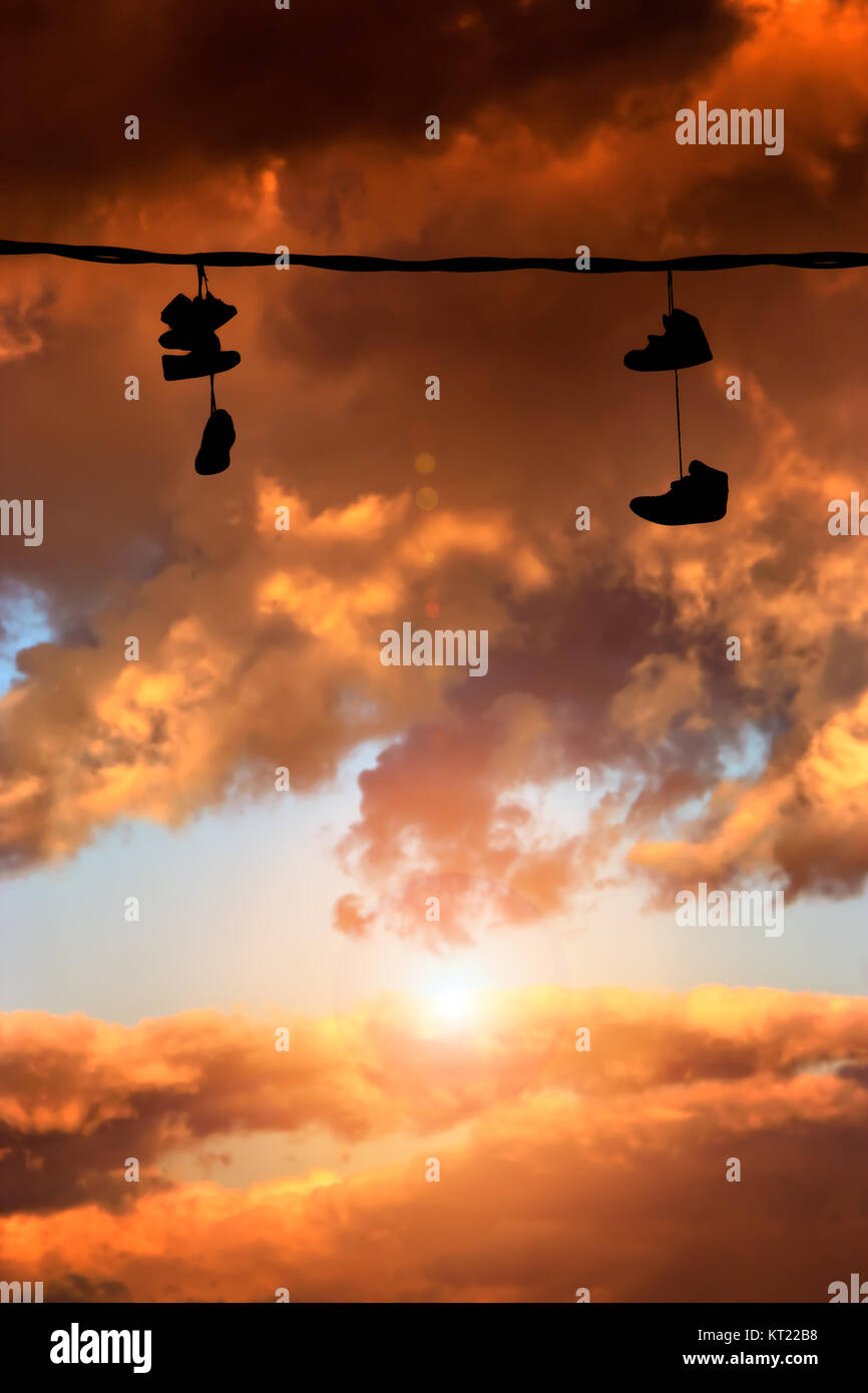 Sneakers hanging at sunset Stock Photo - Alamy
