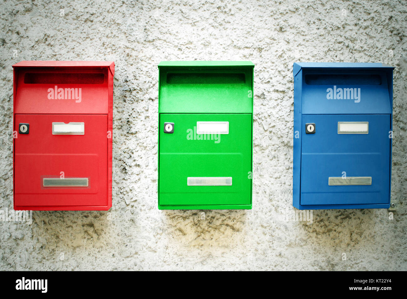 Photo of three colored mailboxes hanging on a wall Stock Photo - Alamy