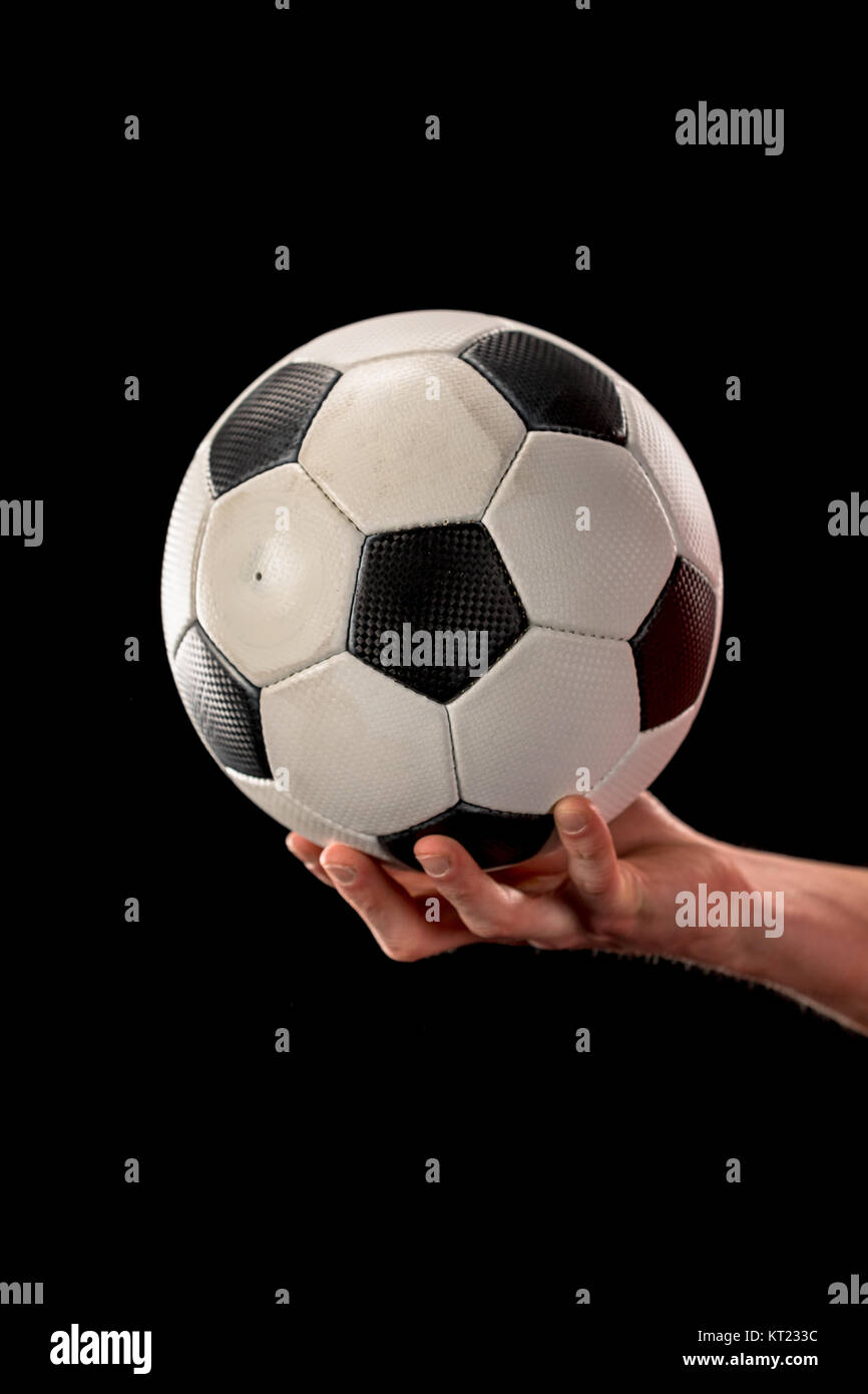 Soccer ball in hand Stock Photo - Alamy