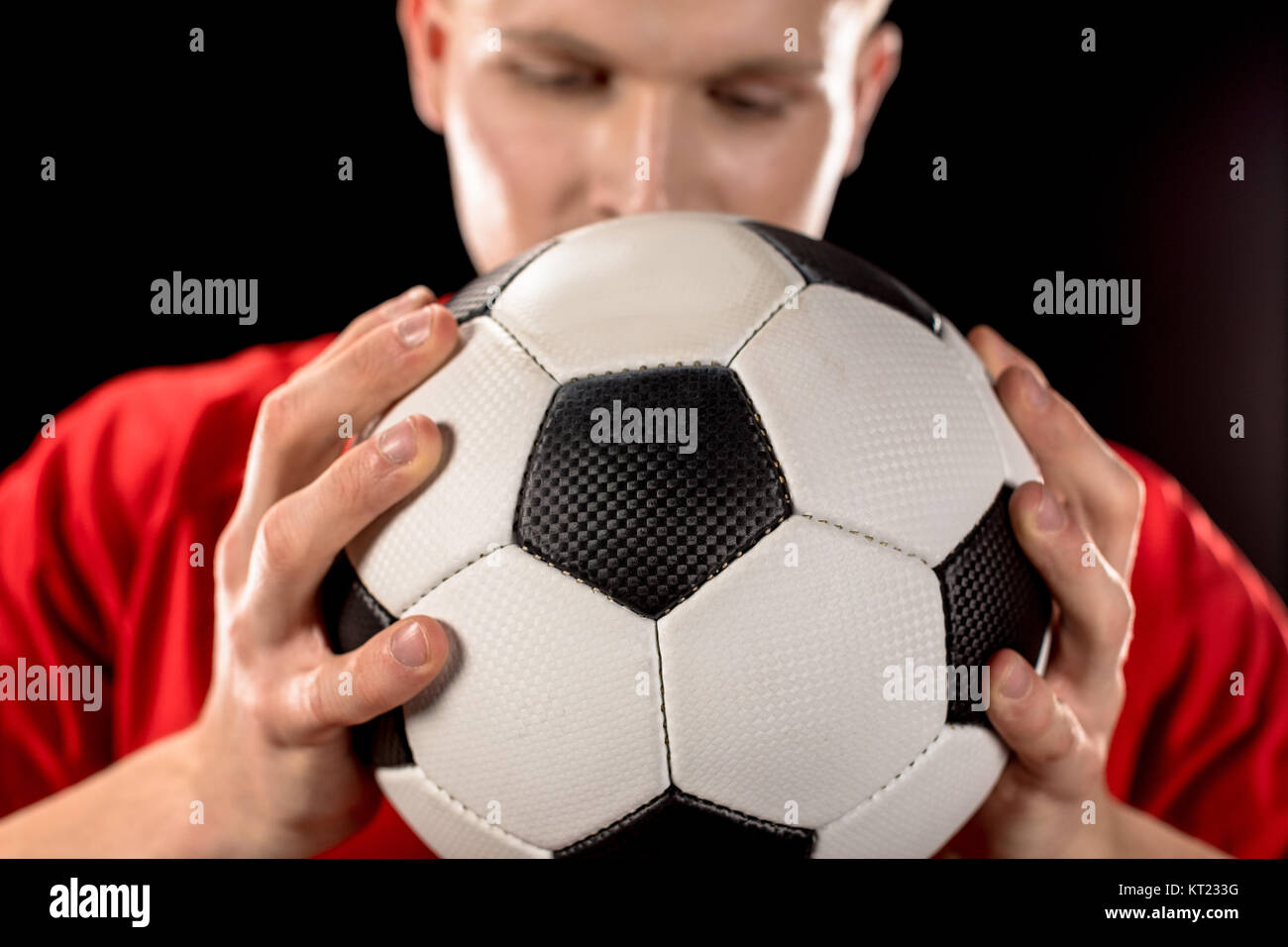 Soccer player holding ball Stock Photo - Alamy