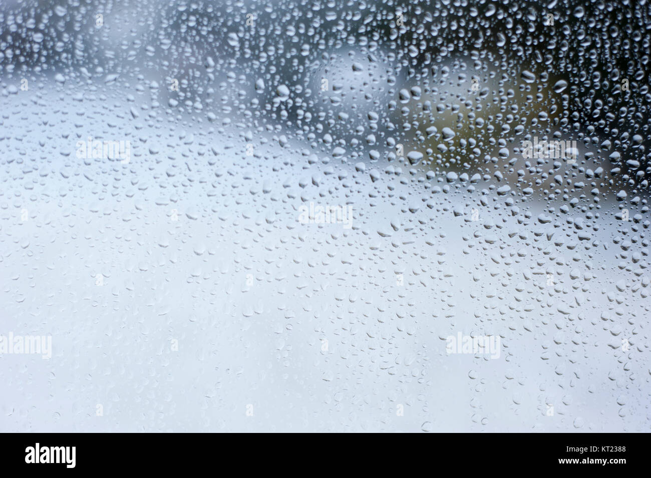 Water droplets running down a glass window on a snowy day Stock Photo ...