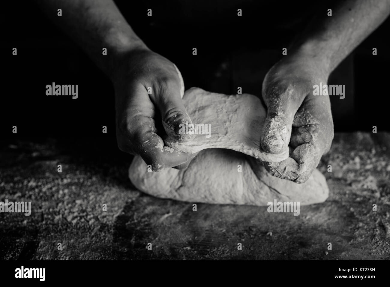 Baker examining dough Stock Photo - Alamy