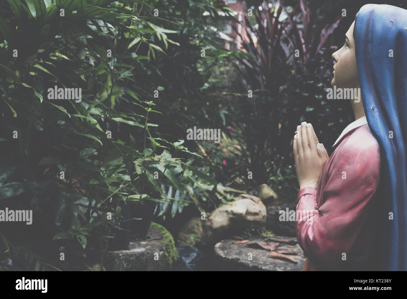 praying woman with folded hand statue. sculpture in roman catholic ...