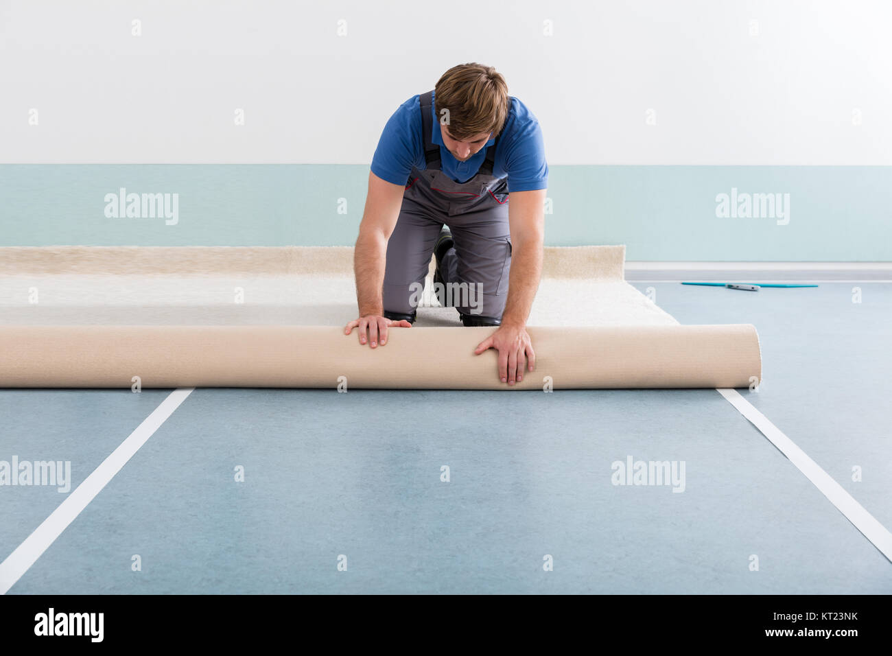 Young Man Laying Carpet Stock Photo - Alamy