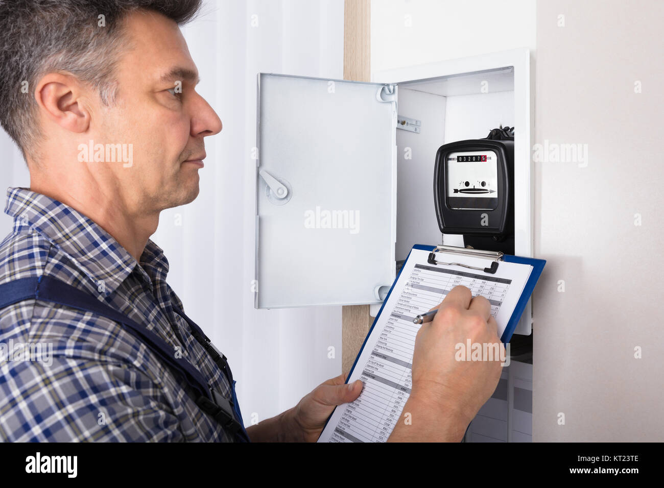 Male Technician Writing Reading Of Meter Stock Photo - Alamy